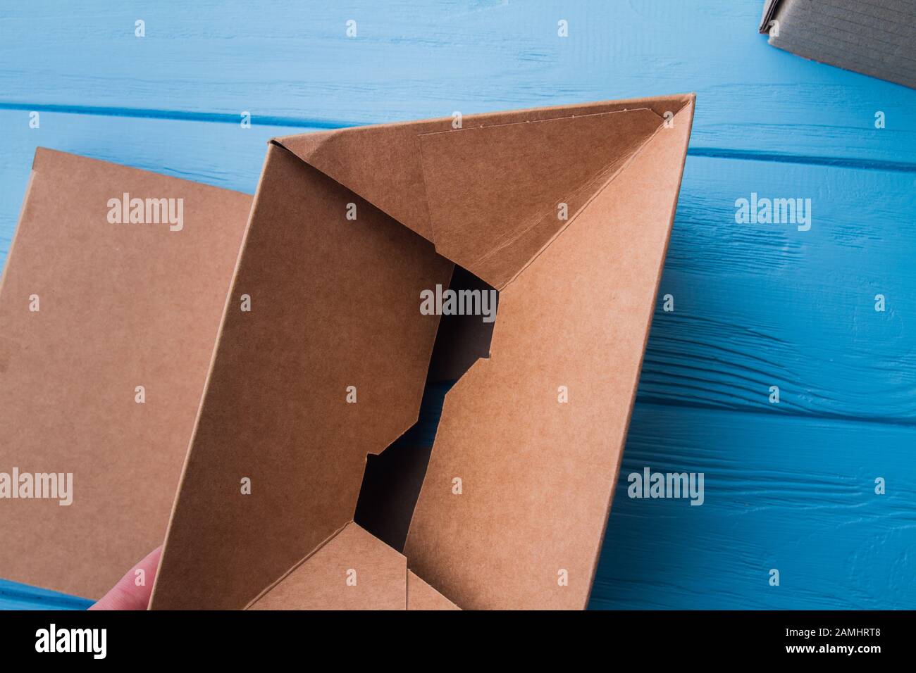 Uncovering carton cardboard box, close-up Stock Photo - Alamy