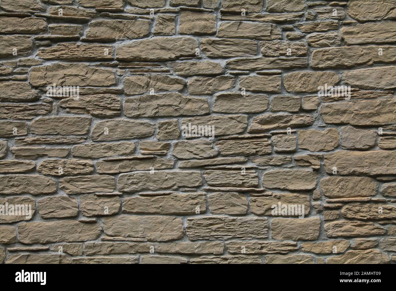 Beige-colored decorative stone wall, texture, background. Tan or light ...