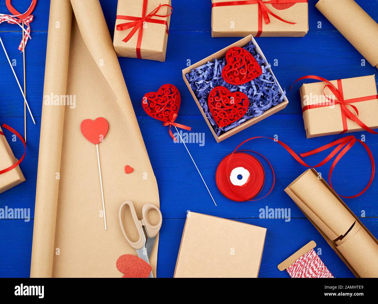 brown kraft paper, packed gift boxes and tied with a red ribbon, red ...