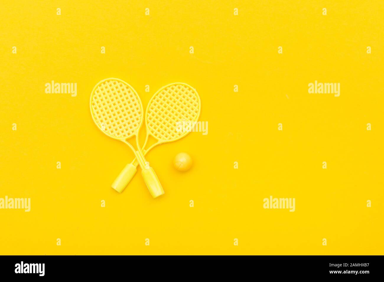 Tennis racket and ball sports on yellow background Stock Photo - Alamy