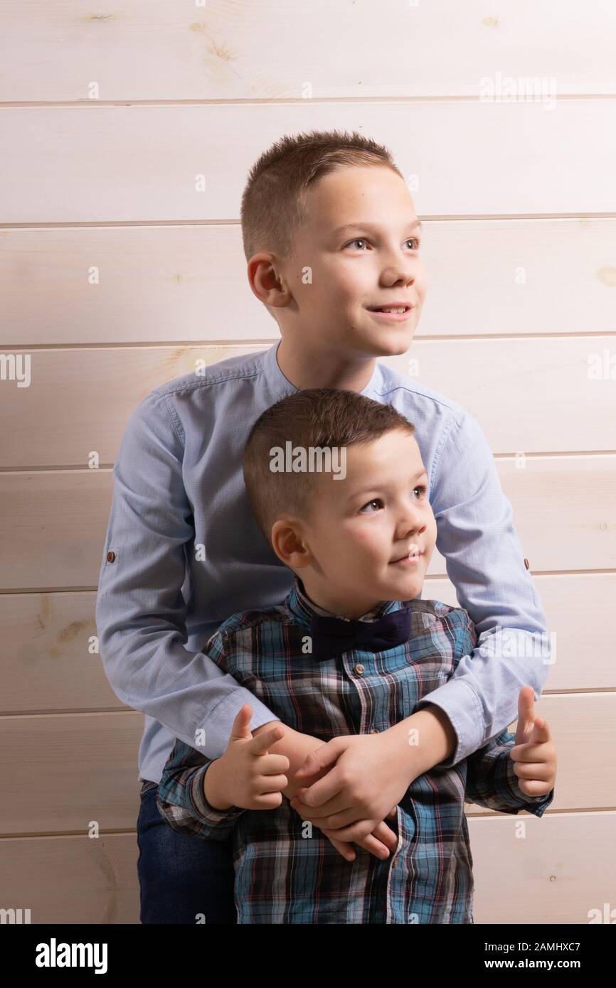 A 4-year-old boy in a blue klepy shirt cries on a light wooden ...