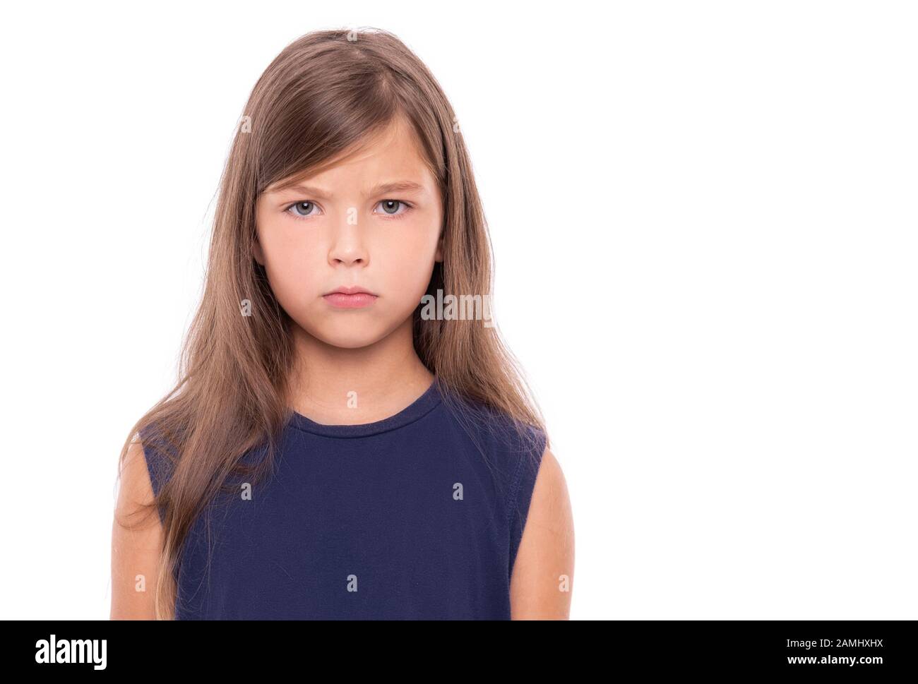 Angry baby girl on white background Stock Photo - Alamy
