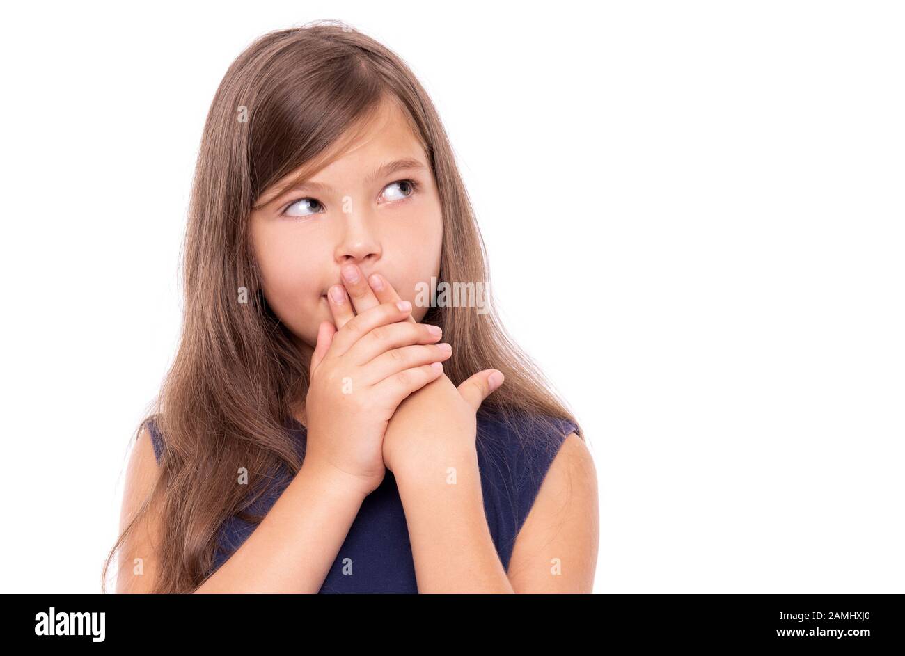 Pensive little girl thinks about something. Isolated on a white Stock ...
