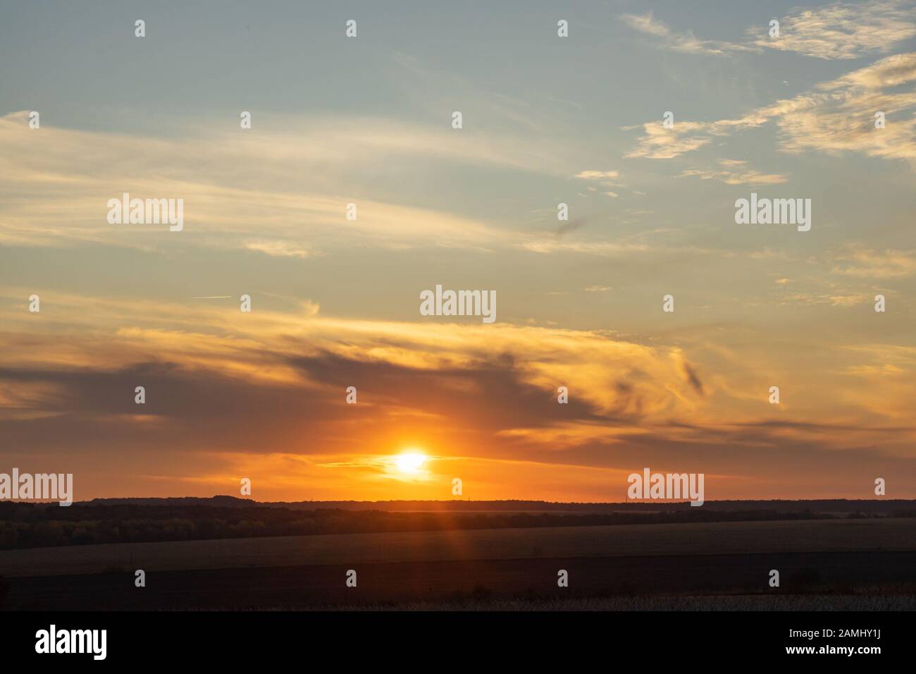 Beautiful orange sunset and field. Endless open spaces Stock Photo - Alamy