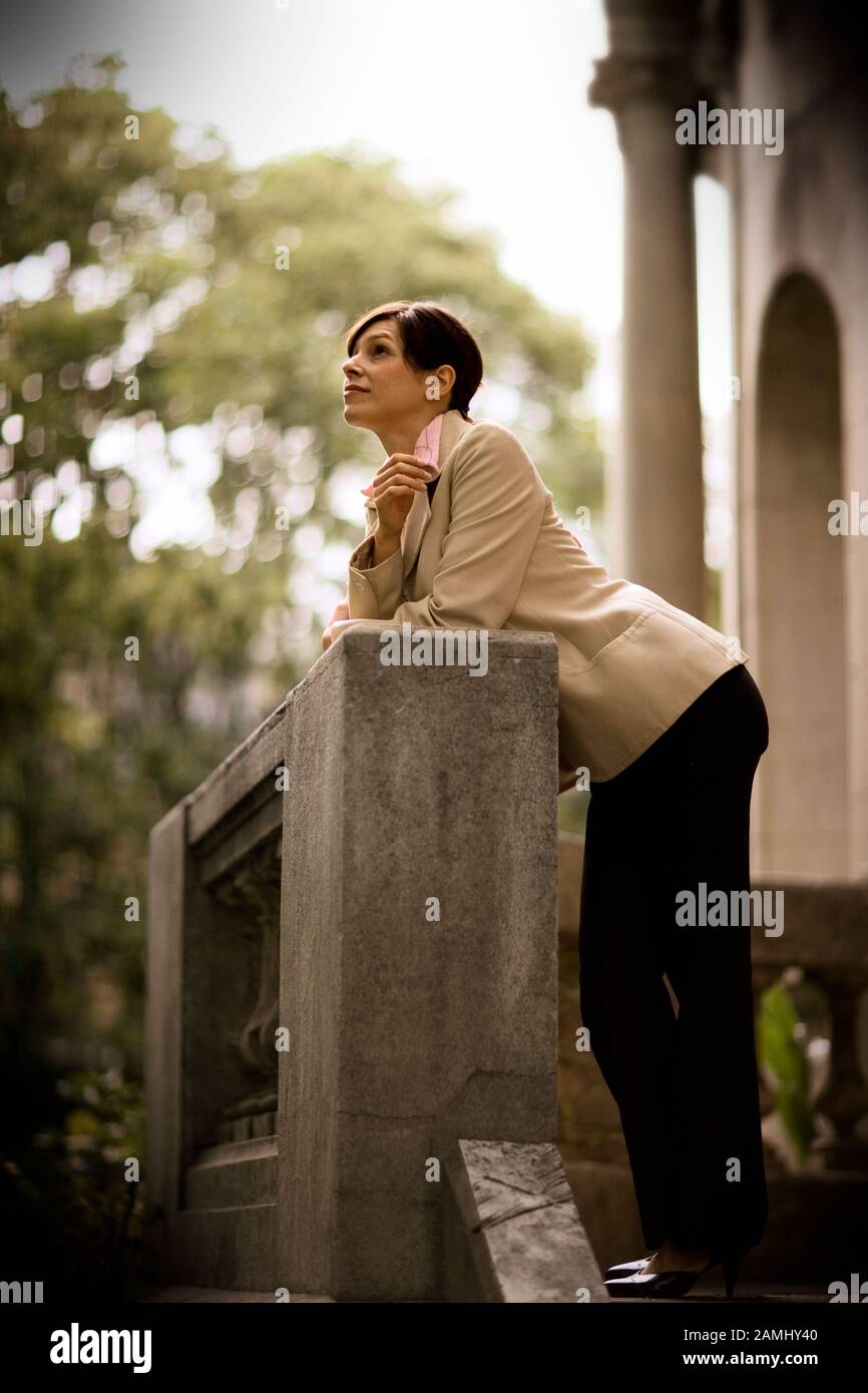 Side view of a young professional leaning on a wall Stock Photo - Alamy
