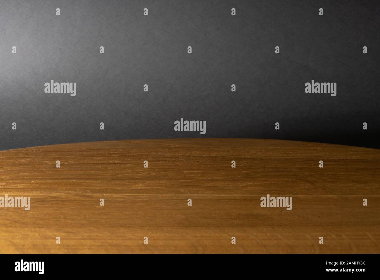 Wooden table and dark gray background. A place to place various items ...