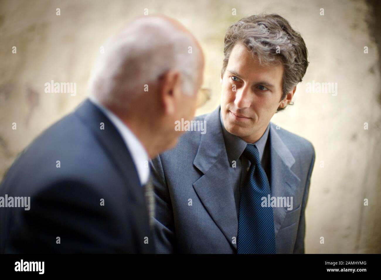 View of two men having an animated conversation Stock Photo - Alamy