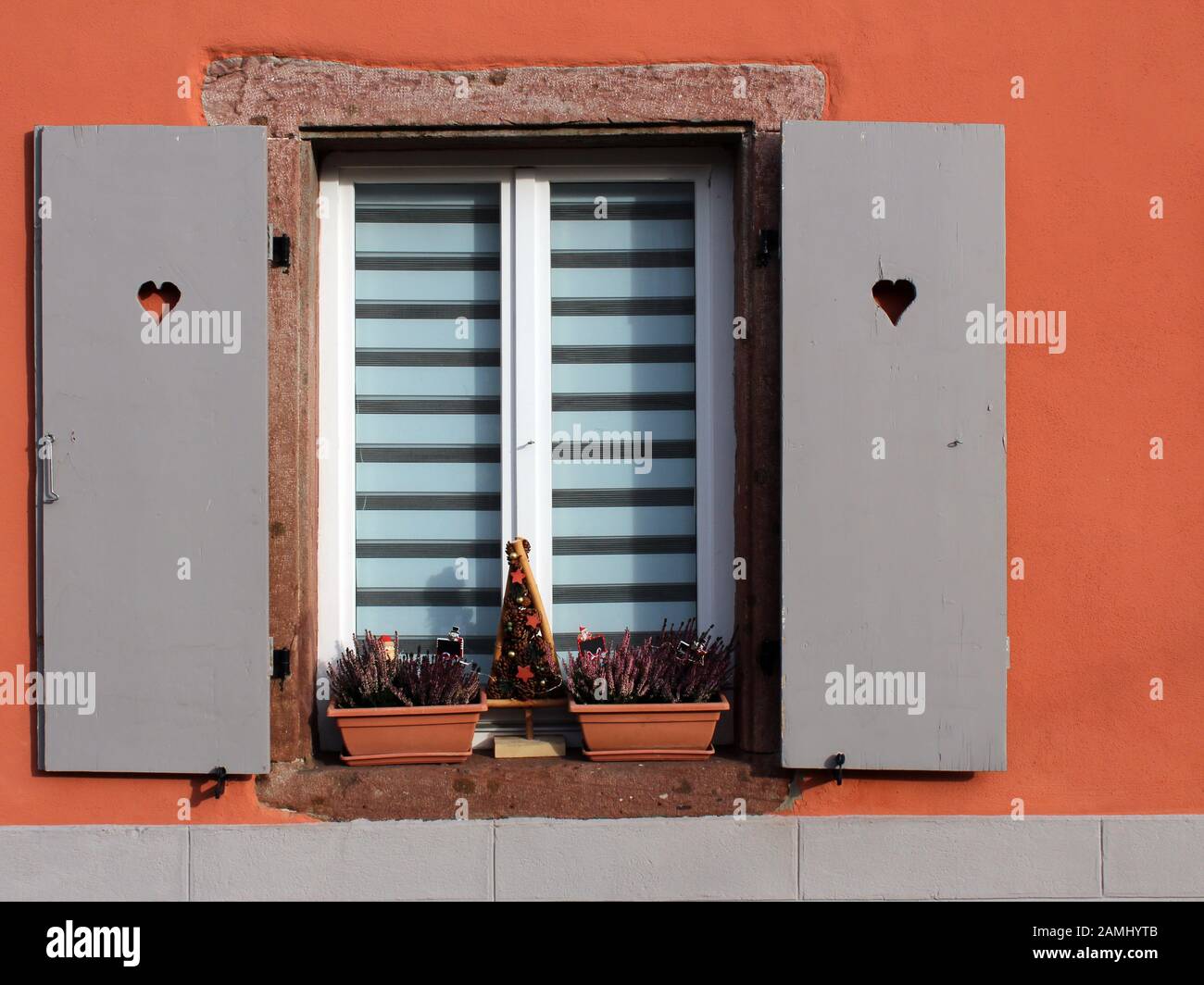Shutter window with open wooden boards and flower pots on the window ...