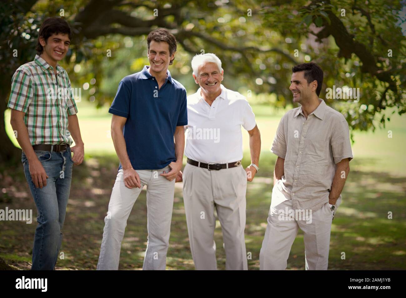 Front view of four men posing for the camera Stock Photo - Alamy
