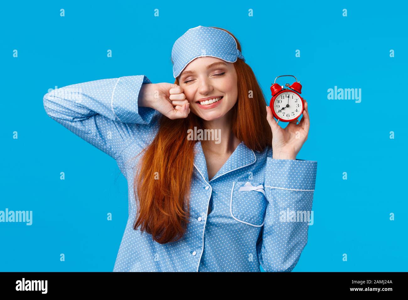 Girl slept well, wake up energized, sleepy stretching with closed eyes ...