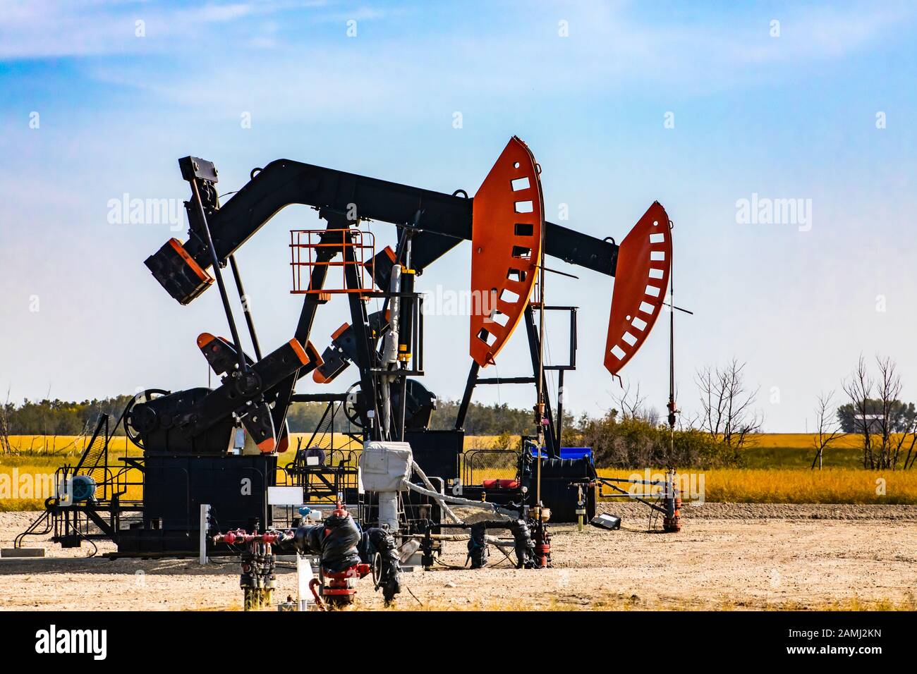 Details of two oil wells in rural Canada. Aka nodding horses, donkeys ...