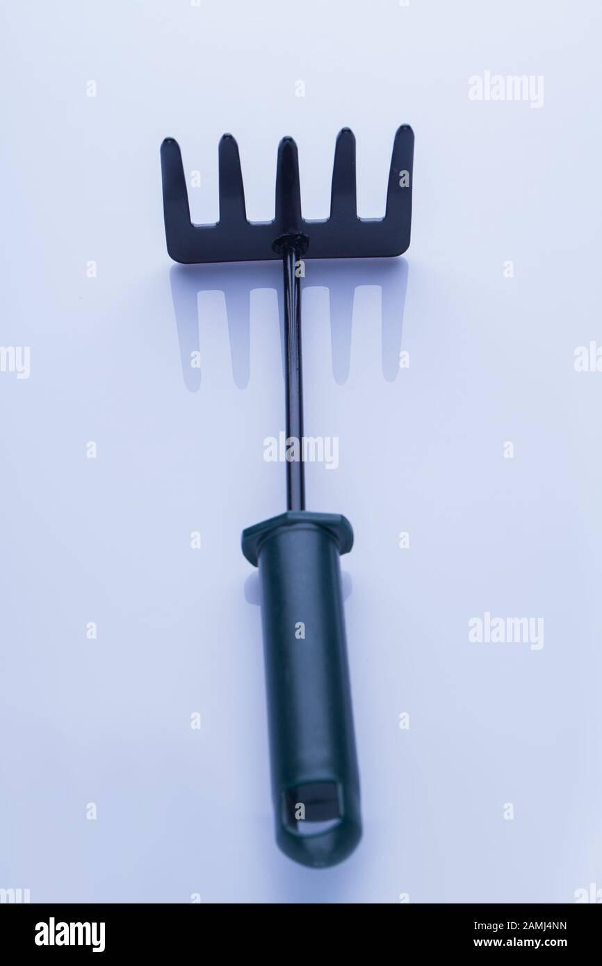 Small black garden rake Stock Photo - Alamy