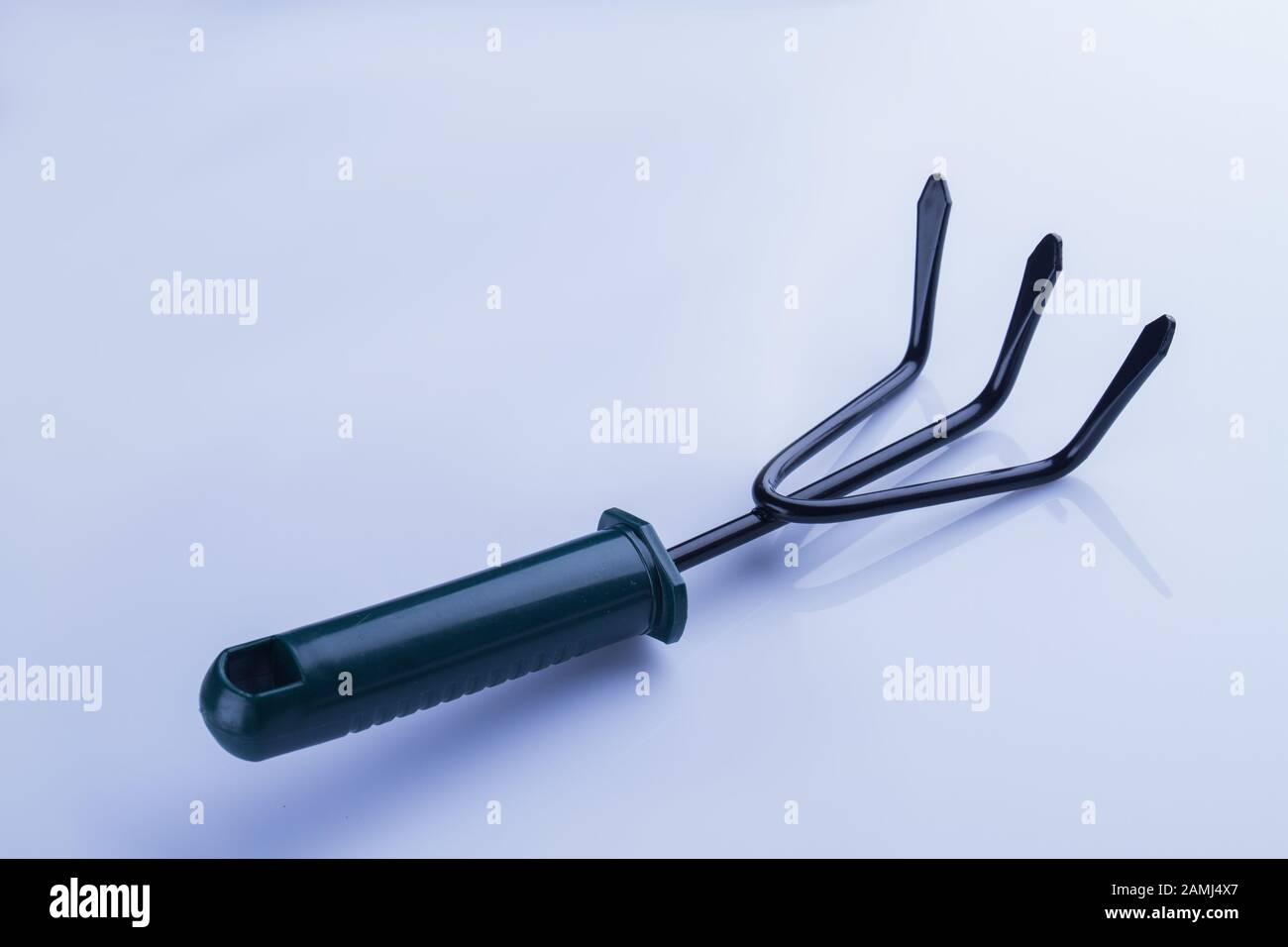 Short three-jaw rake Stock Photo - Alamy