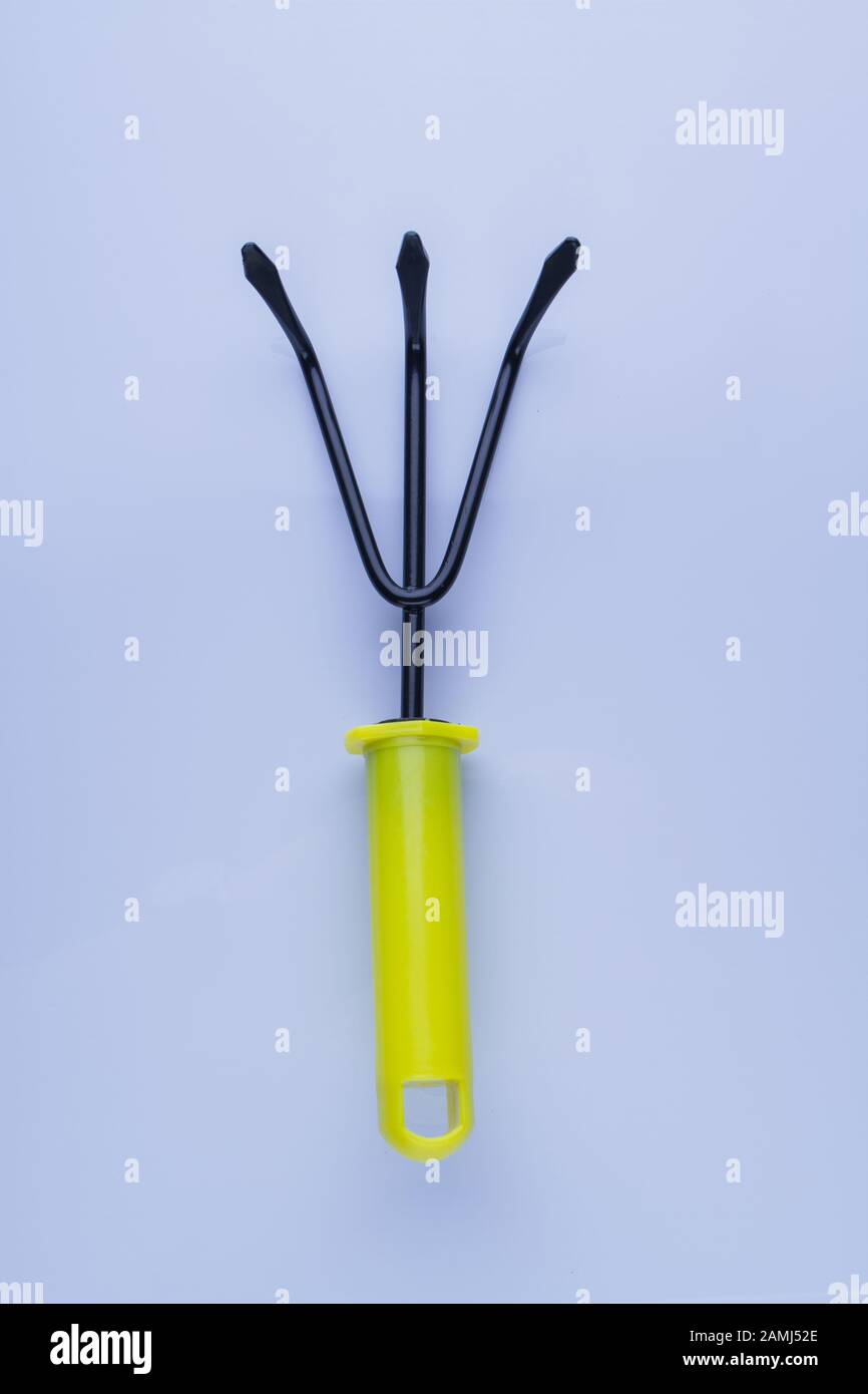 Yellow handed three-jaw rake Stock Photo - Alamy