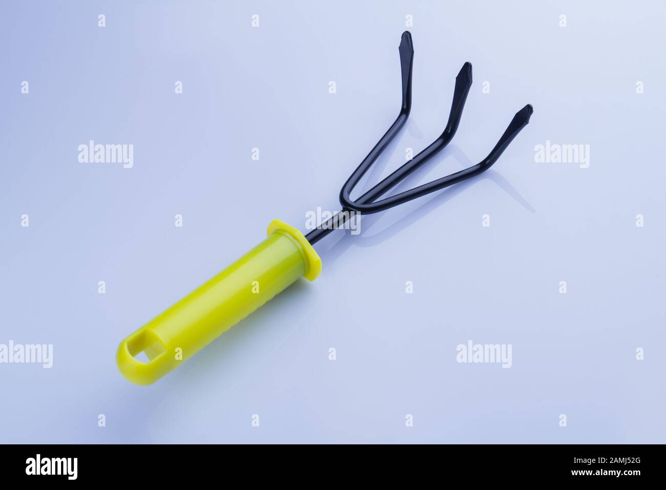 New short three-jaw rake close-up Stock Photo - Alamy