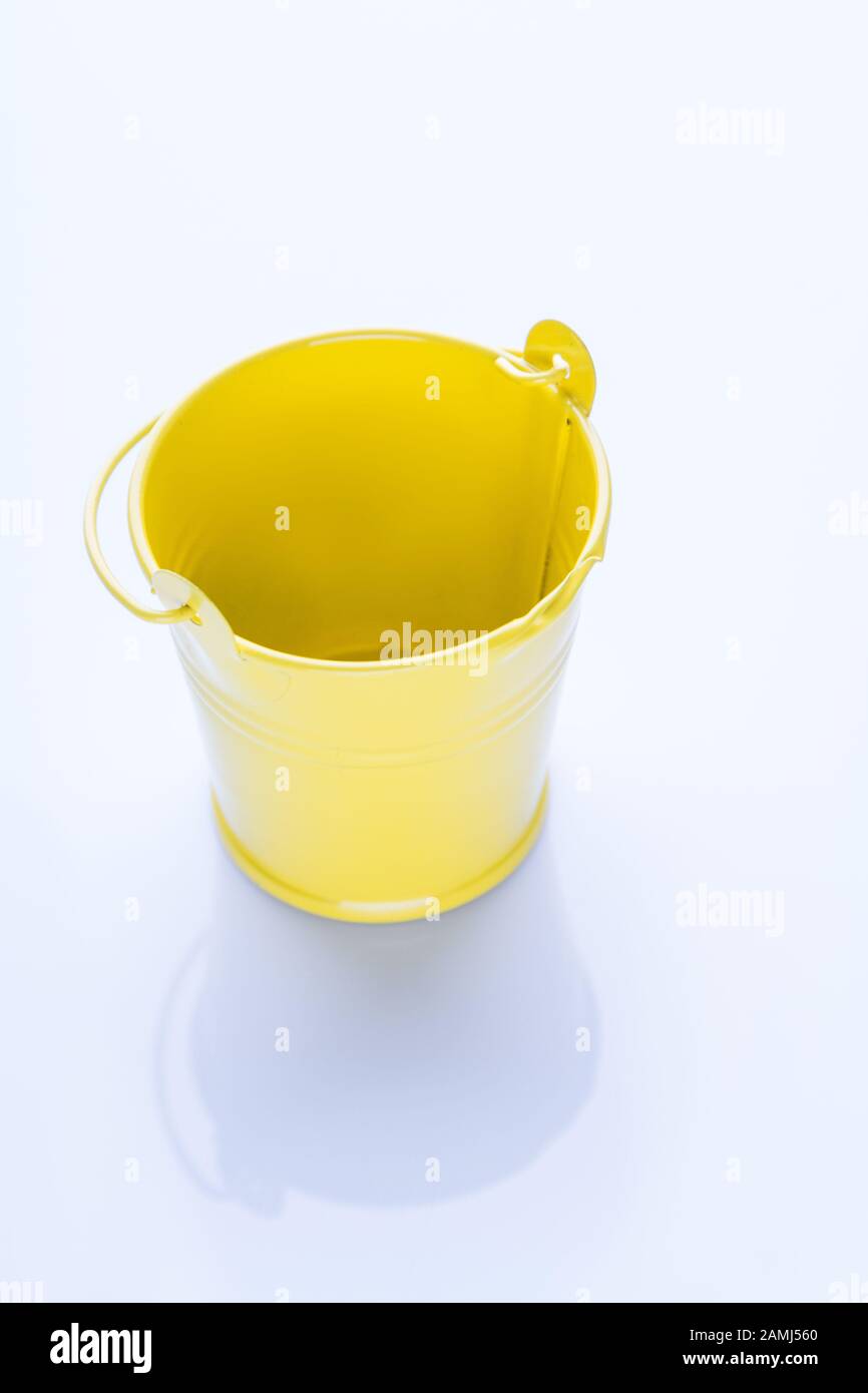 Empty yellow bucket isolated on white Stock Photo - Alamy
