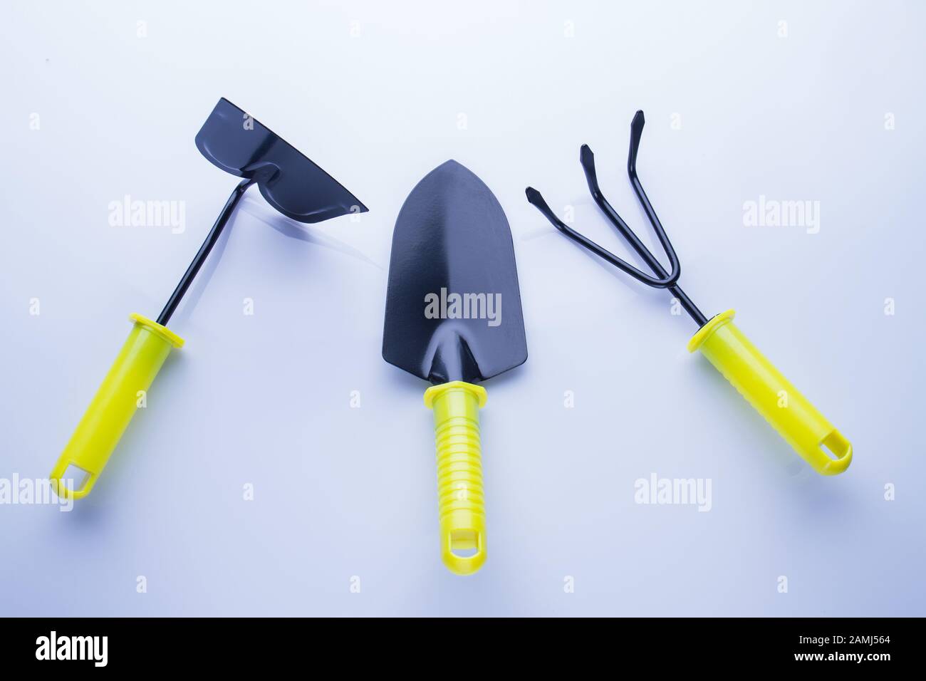Short gardening tools - hoe, rake and trowel Stock Photo - Alamy