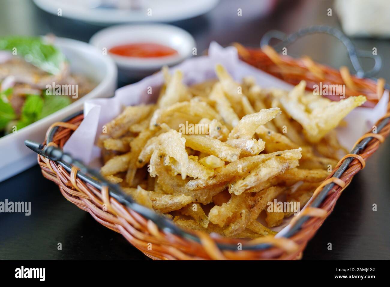 Fried small fishes, Thai river sprat or Minnow, serve on basket on ...