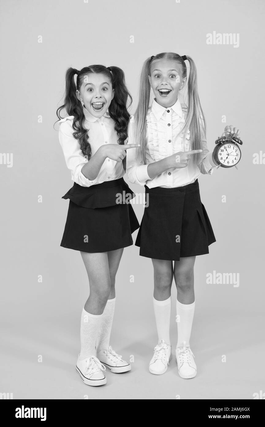 Time for lunch. School schedule. Schoolgirls and alarm clock. Children ...