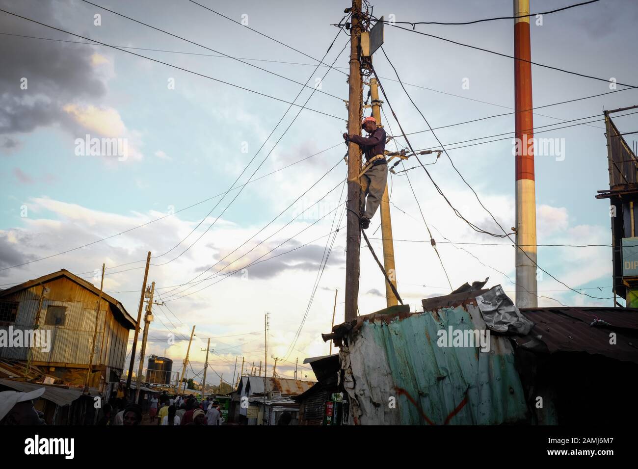 A man is seen fixing illegal connections from a legal power post set up ...