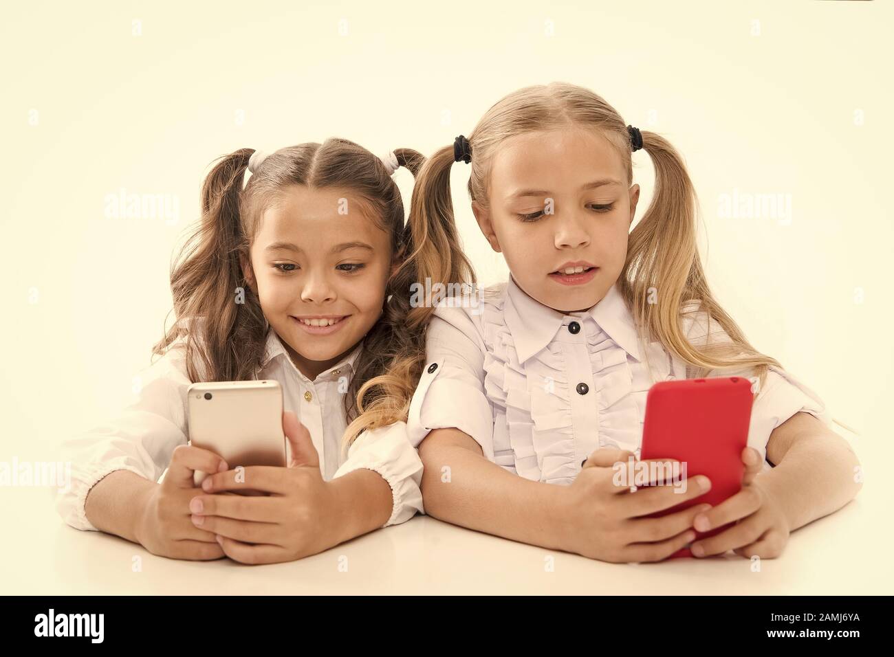 Smart pupils. Little pupils texting message during class isolated on ...