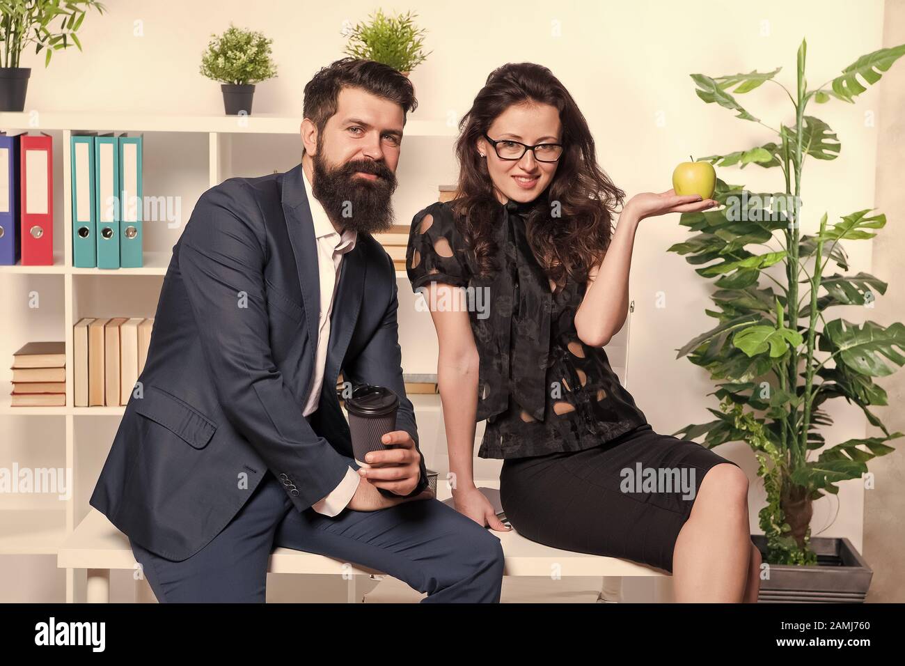 Lunch time. Business partners having breakfast office background ...