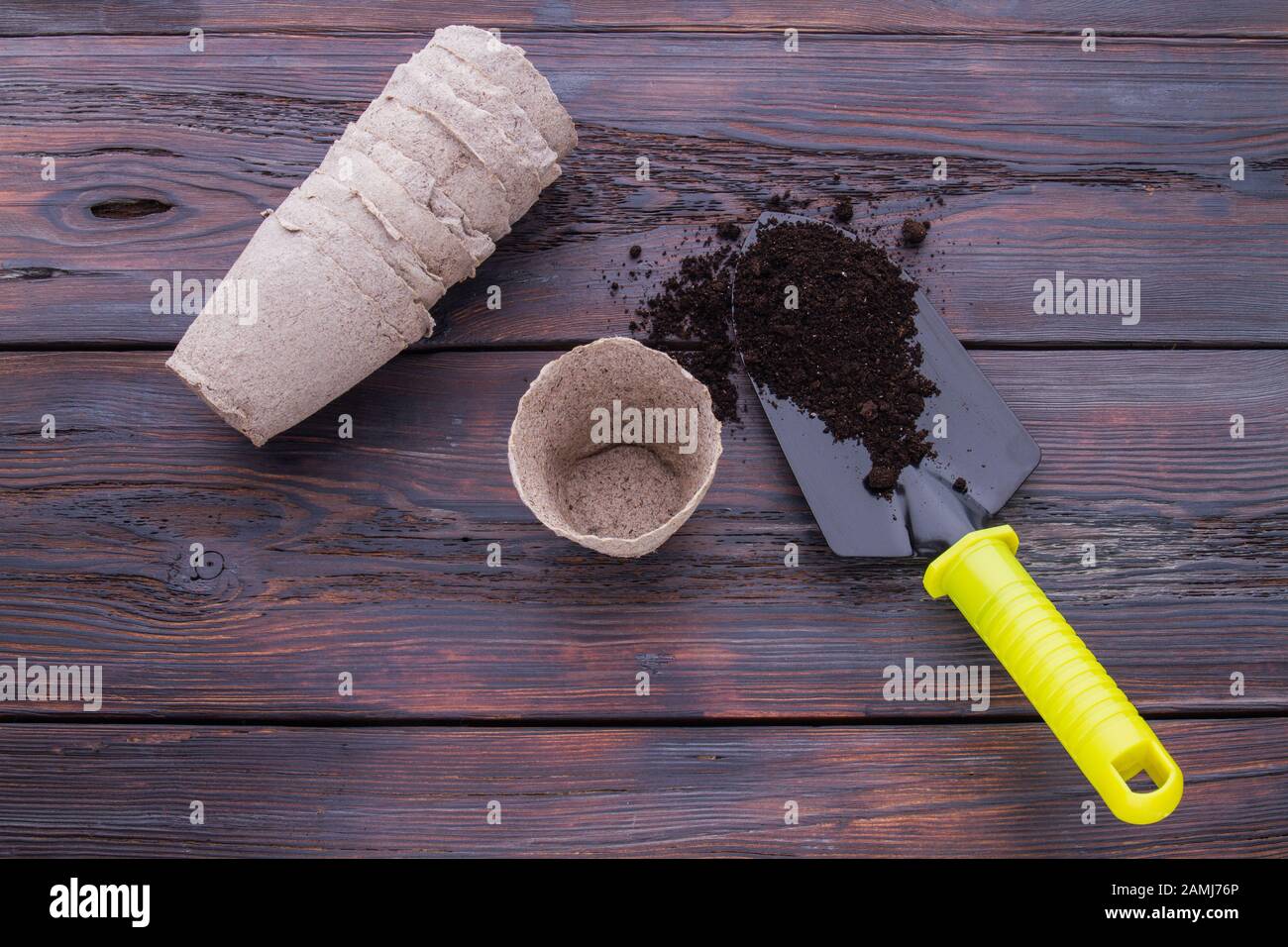 Trowel with soil and disposable cardboard cups for plants Stock Photo ...
