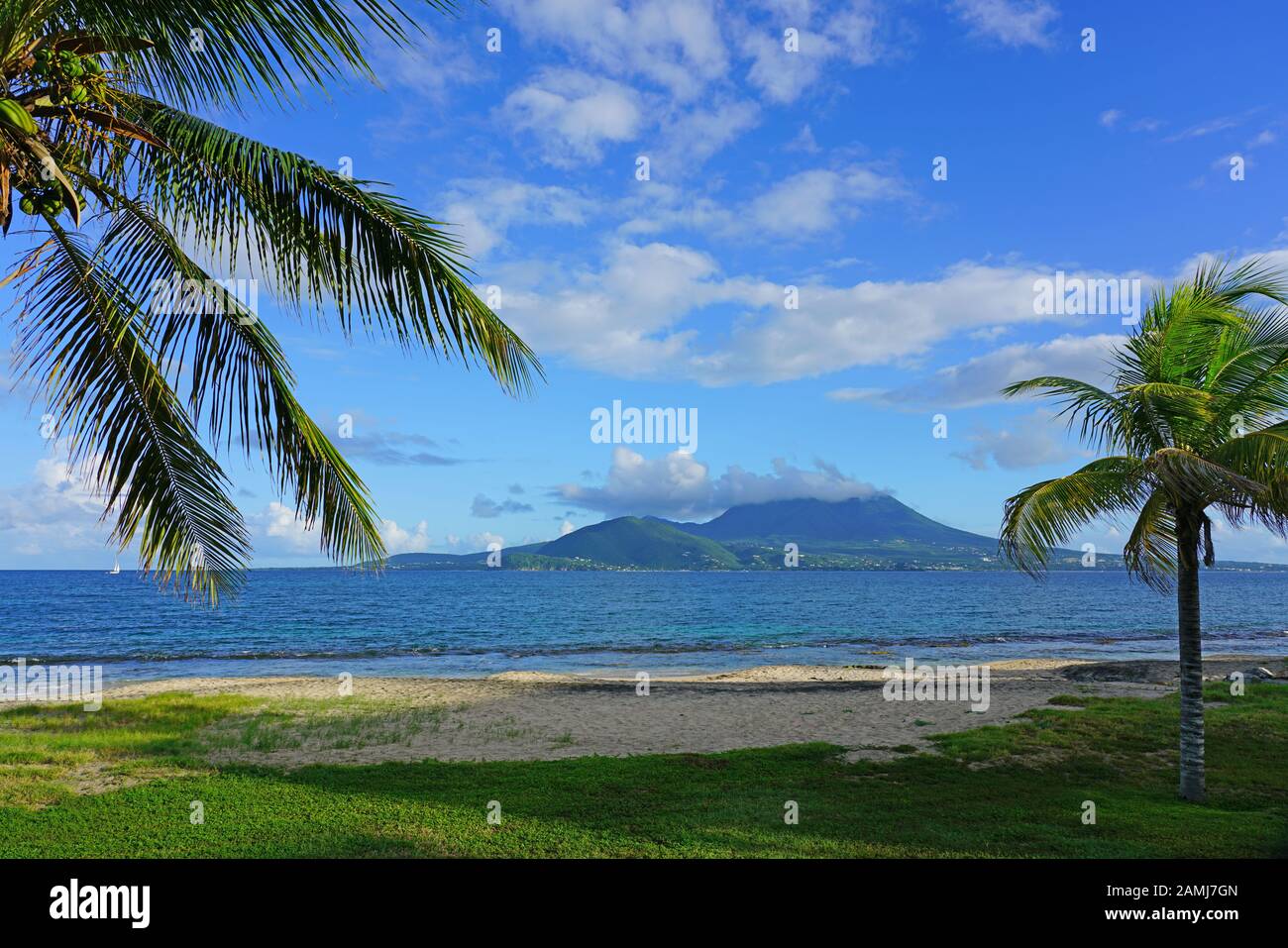 Day view of the Nevis Peak volcano across the water from St Kitts Stock ...