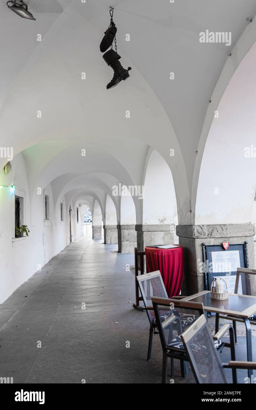 Tables from a cafe outside a vaulted walkway, Prague, Czech Republic ...