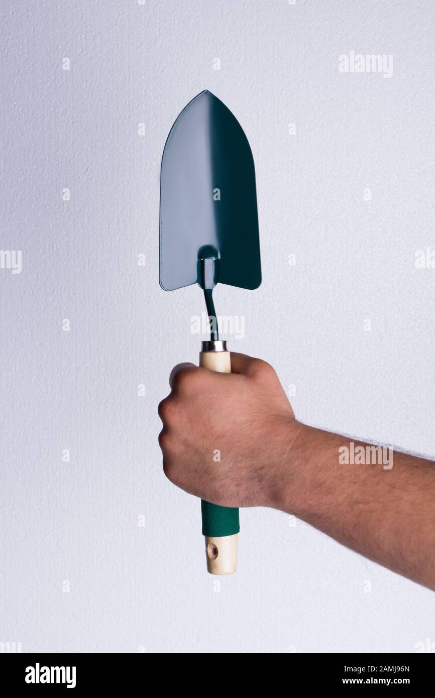 Hand's holding garden trowel Stock Photo - Alamy