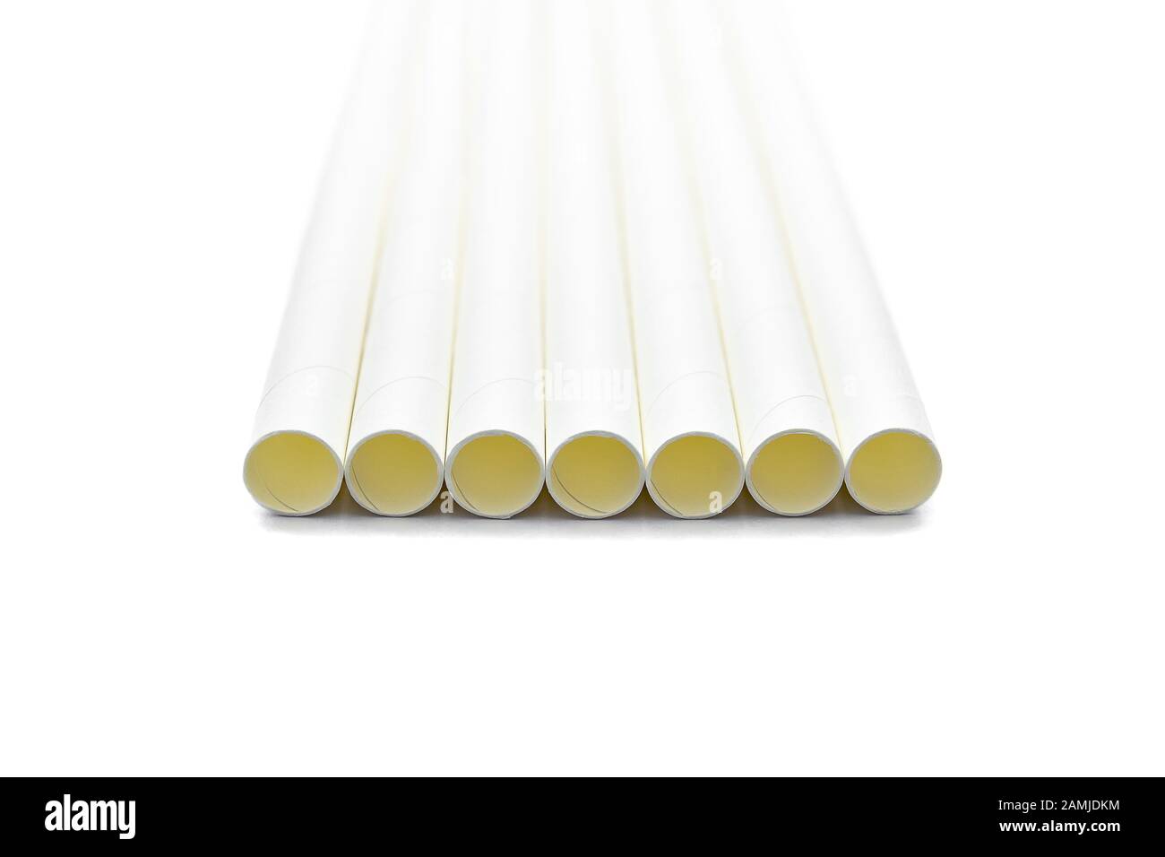Close up white paper straws laying flat isolated on white background ...
