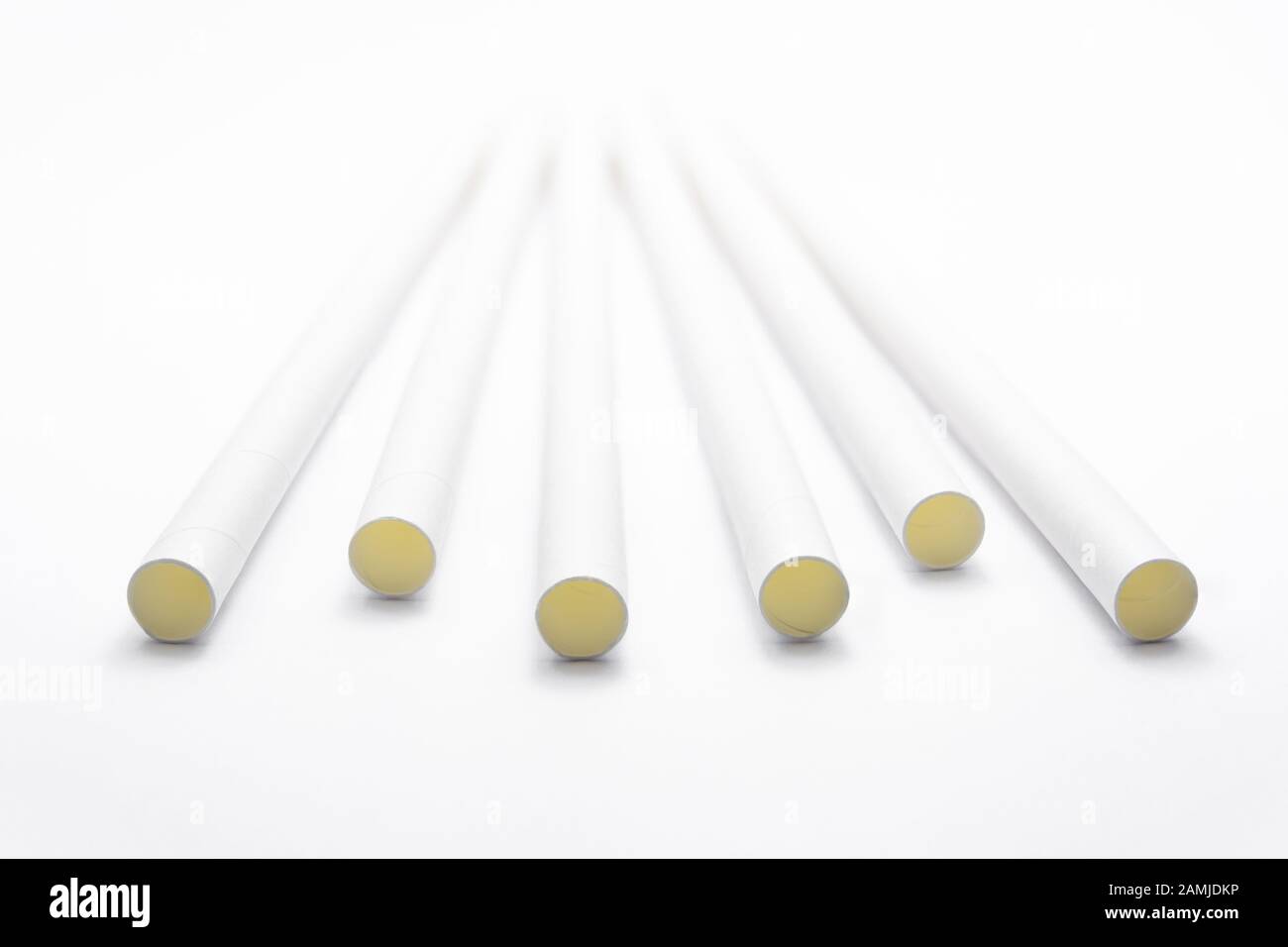 Close up white paper straws laying flat isolated on white background ...