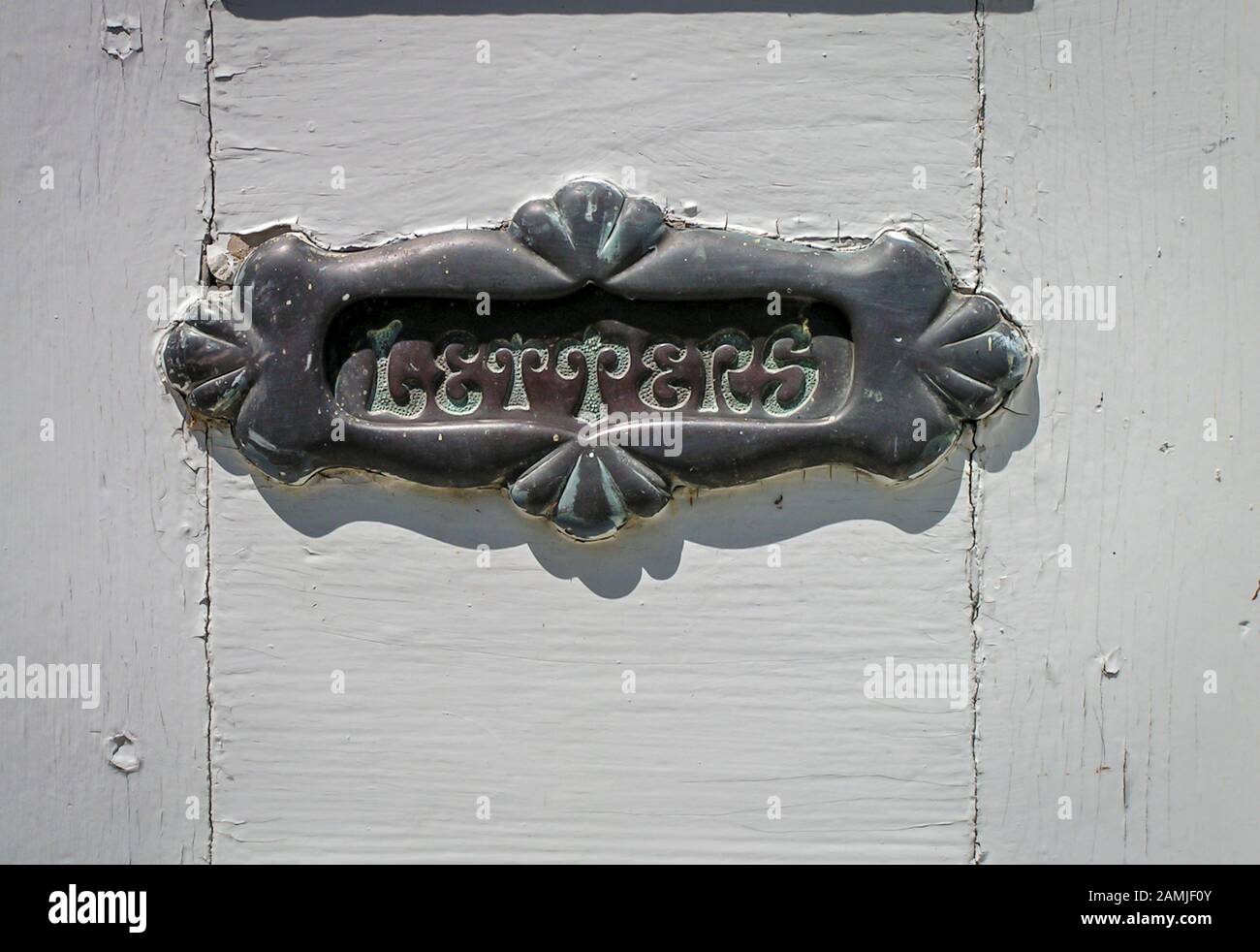 Mailbox slot in a wooden door painted white Stock Photo - Alamy