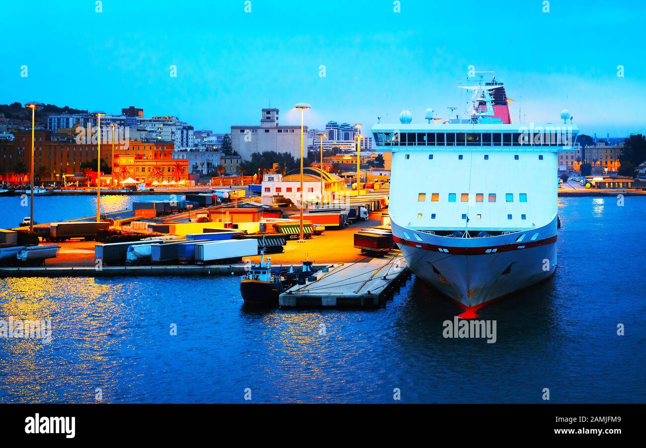 Large car and passenger ferry in port of Cagliari dusk reflex Stock ...