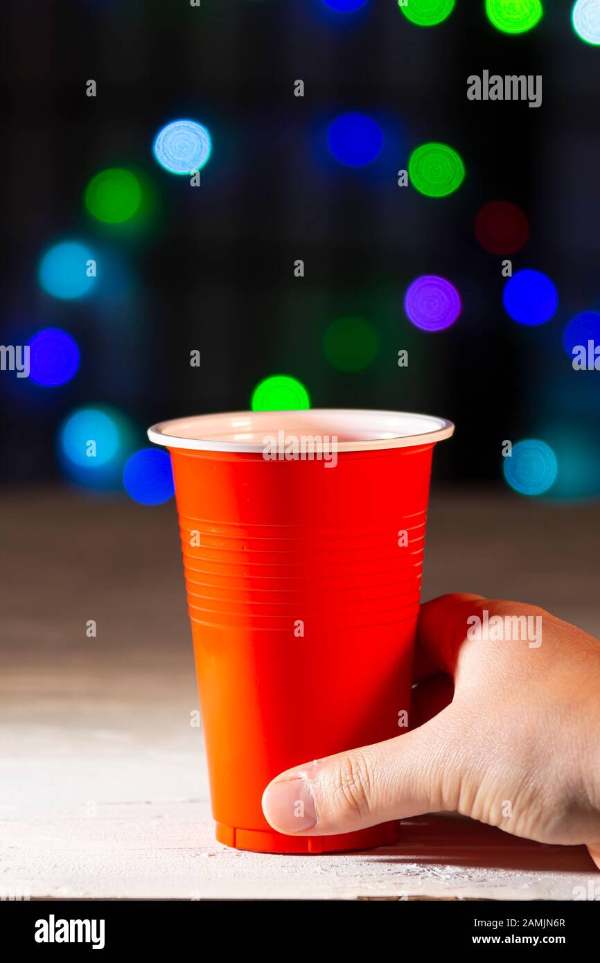 Hand holding a one use cup with lights on the background Stock Photo ...