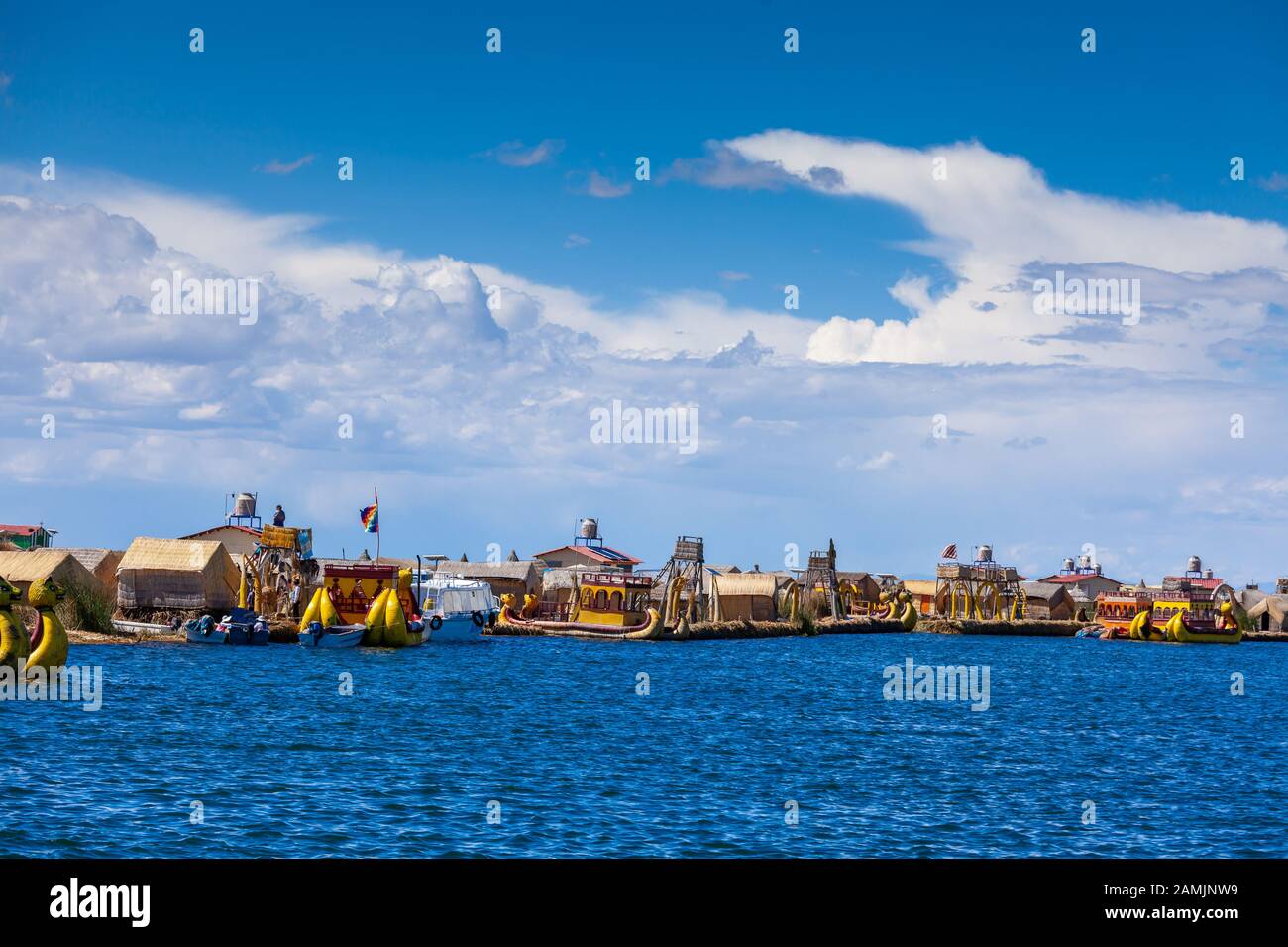 View of the floating islands of Uros, at a distance, clouds, on Lake ...