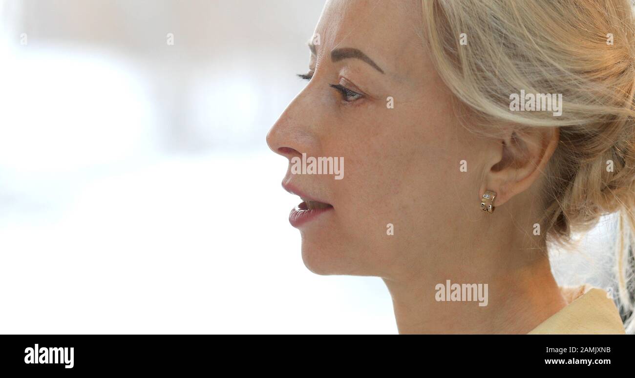 Profile of tender adult lady speaks Stock Photo - Alamy