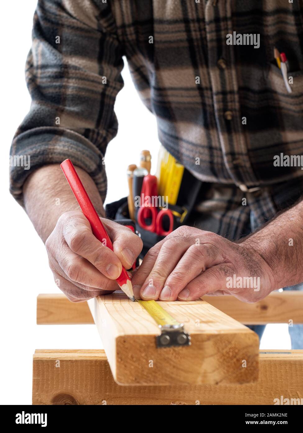 Close-up. Carpenter with pencil and the meter marks the measurement on ...