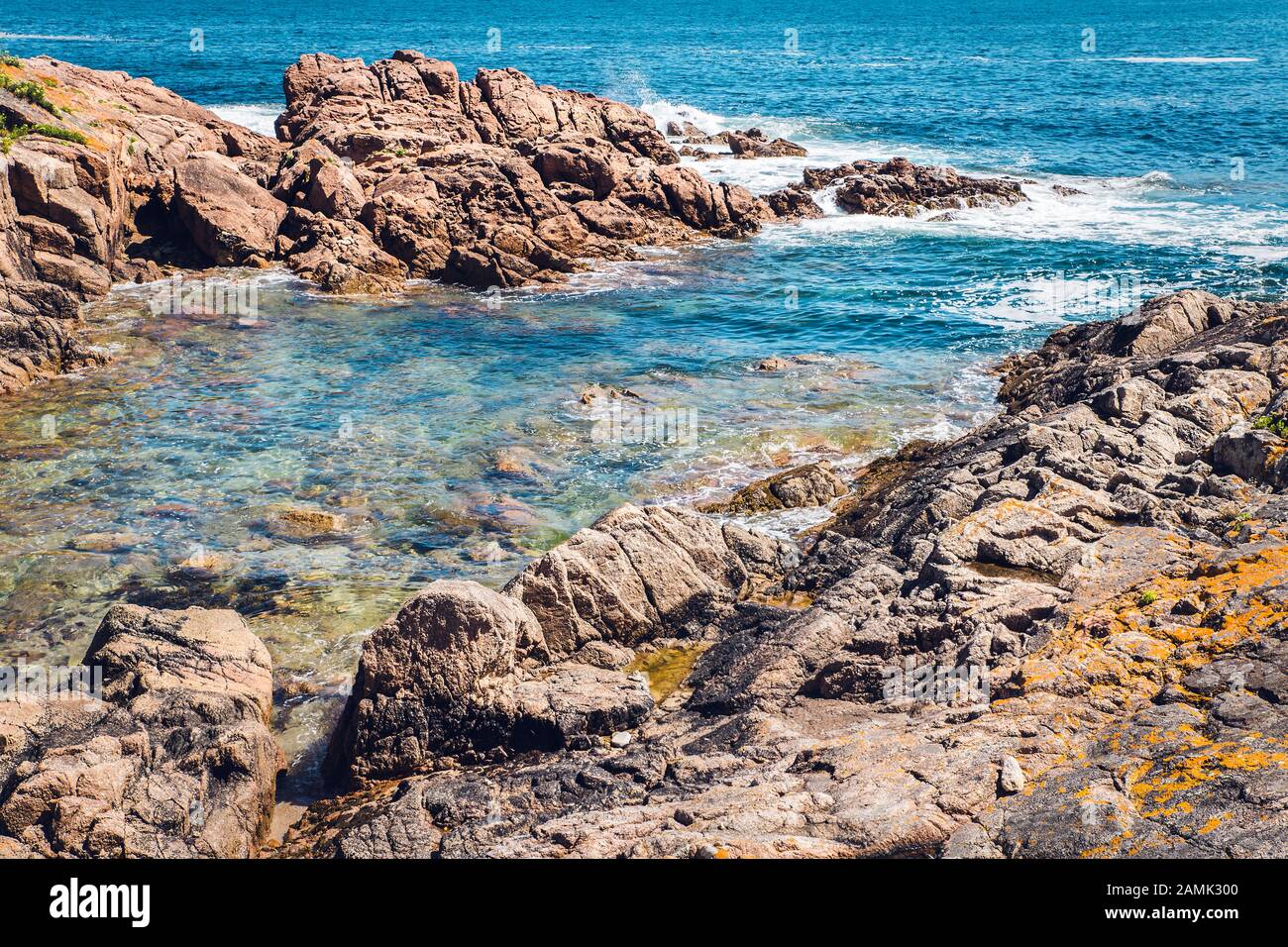 Seashore with cliffs and waves crashing on rocks Stock Photo - Alamy