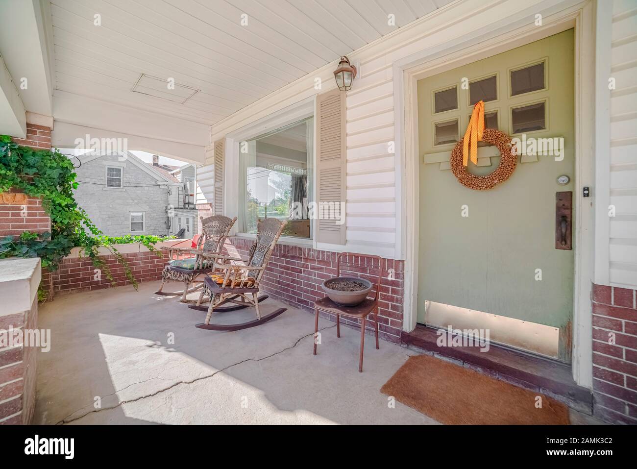 Two rocking chairs on a covered front porch Stock Photo - Alamy