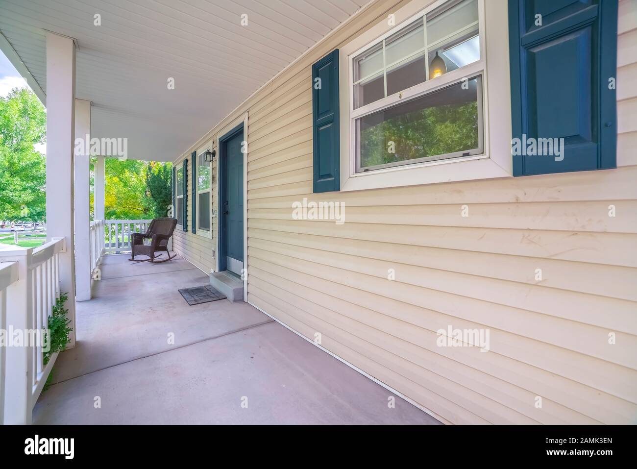 Long covered veranda in front of a timber house Stock Photo - Alamy