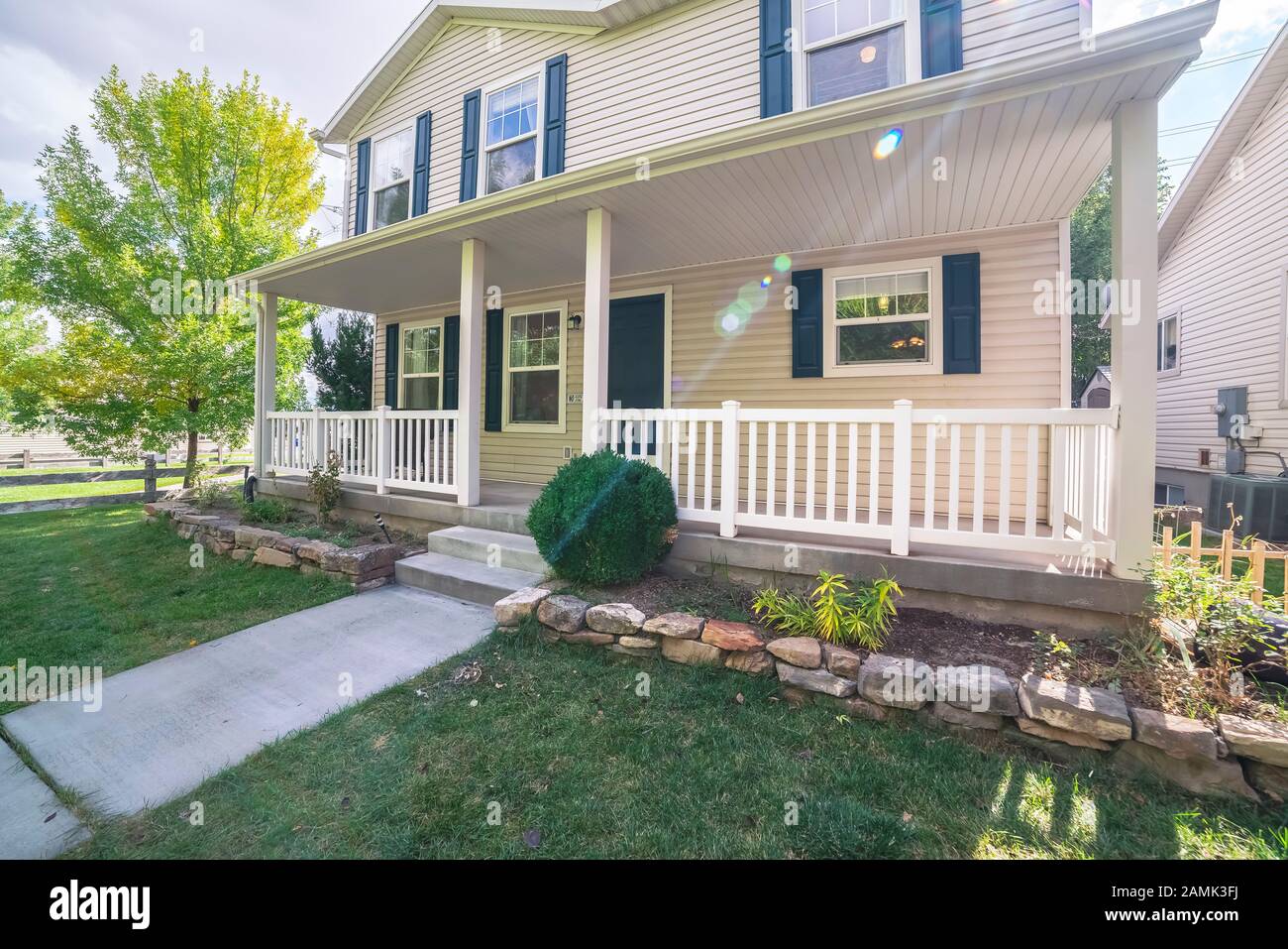 White timber house with shutters and veranda Stock Photo - Alamy