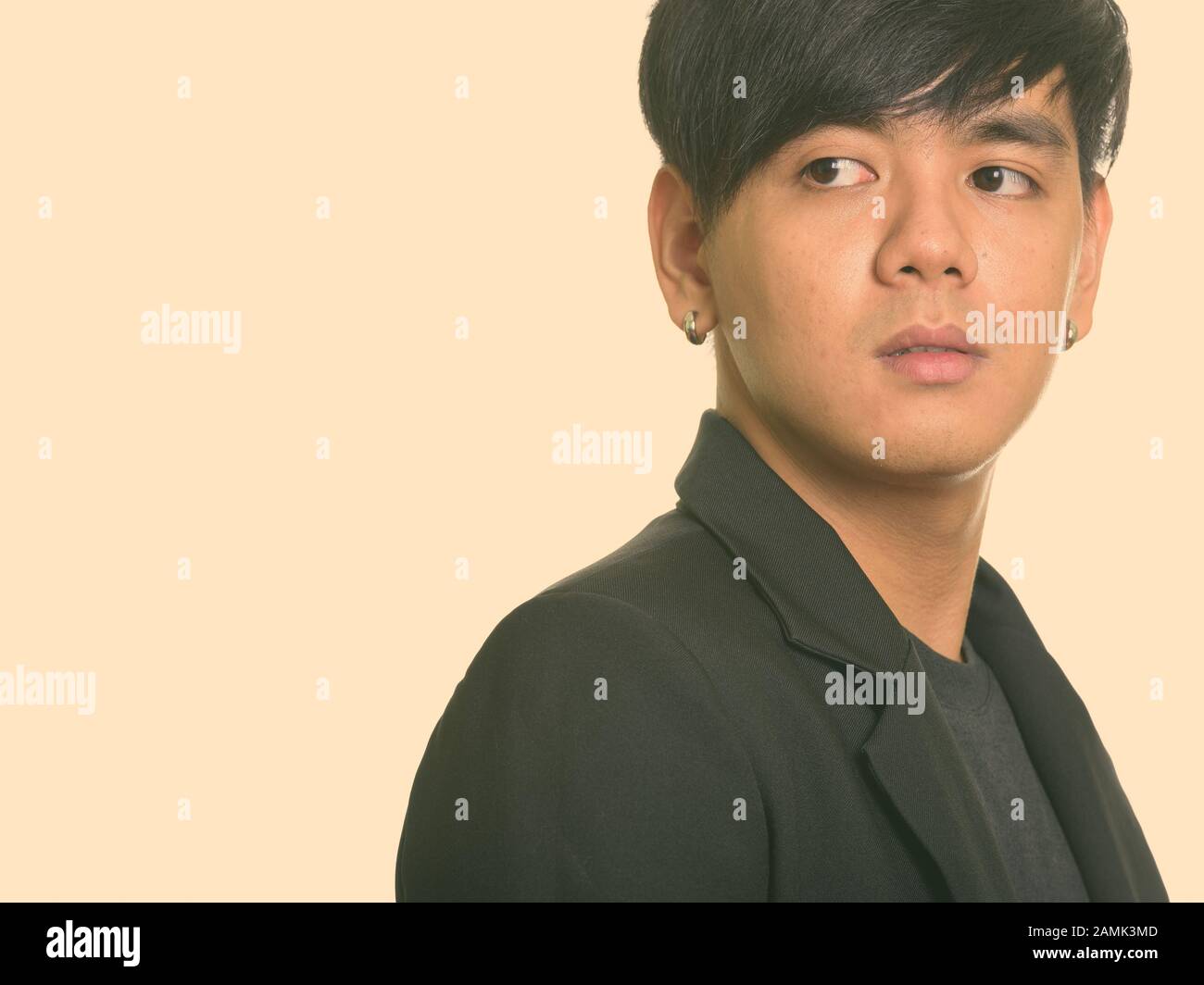 Studio shot of young handsome Filipino man isolated against white ...