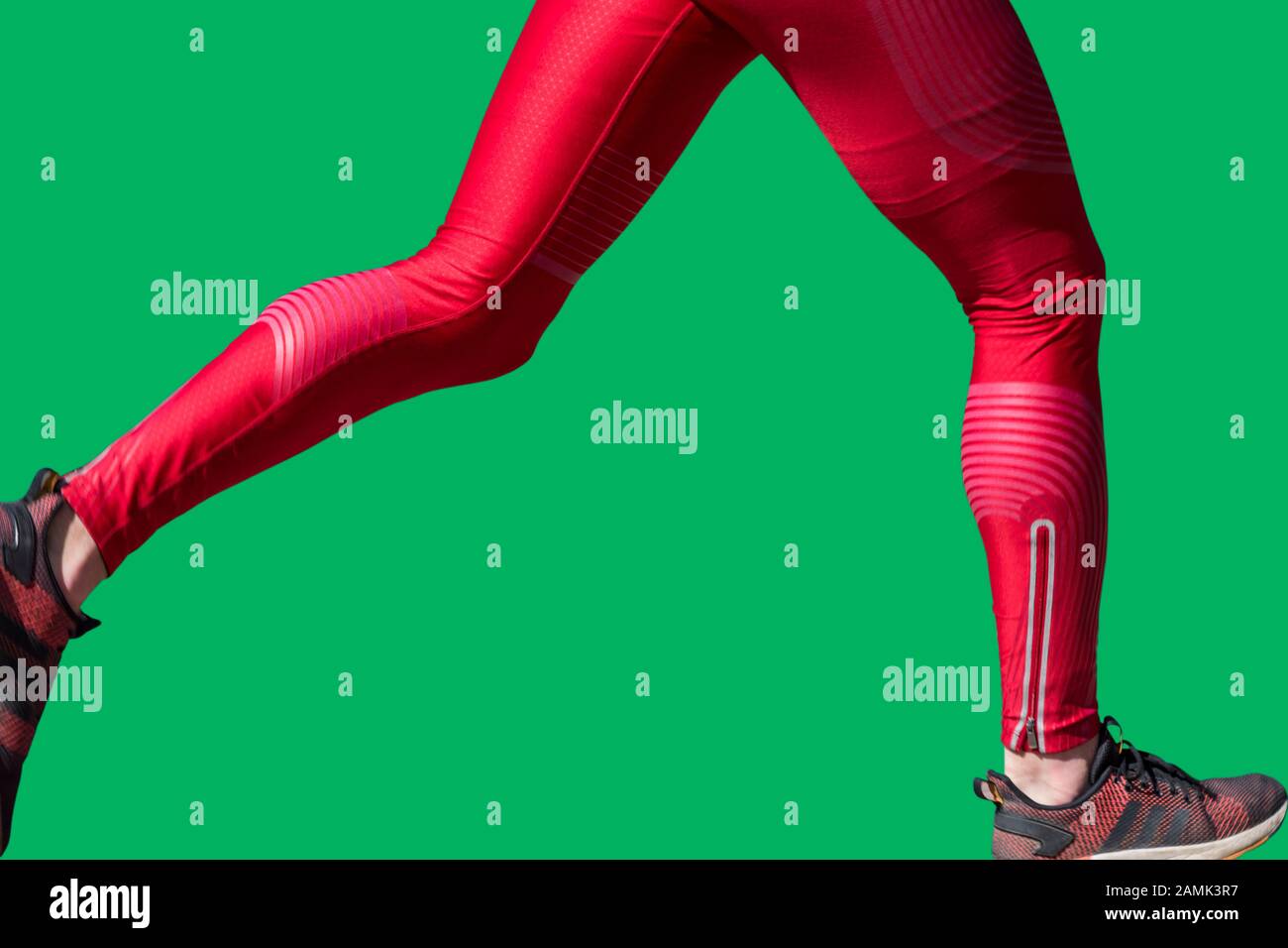 Legs of running man isolated on green surface Stock Photo - Alamy