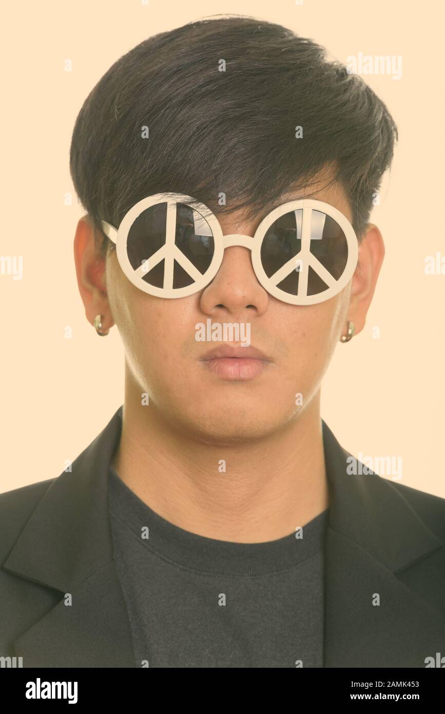 Studio shot of young handsome Filipino man isolated against white ...