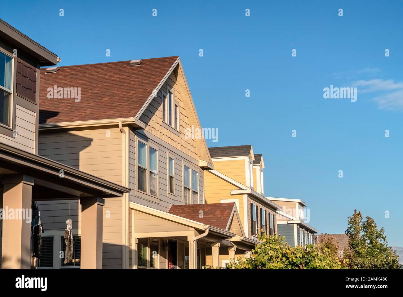 Row of double storey timber clad homes Stock Photo - Alamy