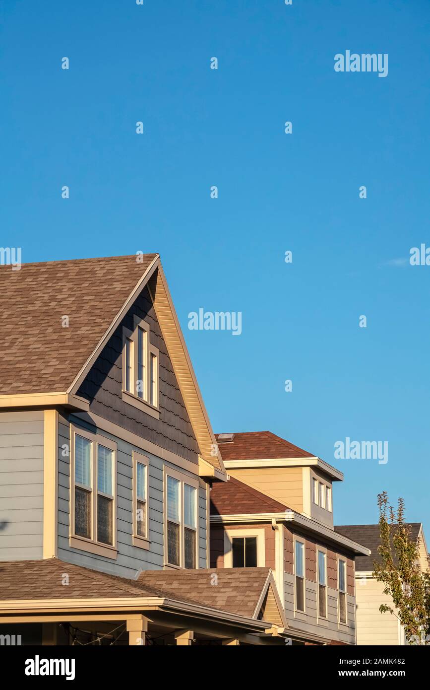 Upper facades of a row of timber clad houses Stock Photo - Alamy