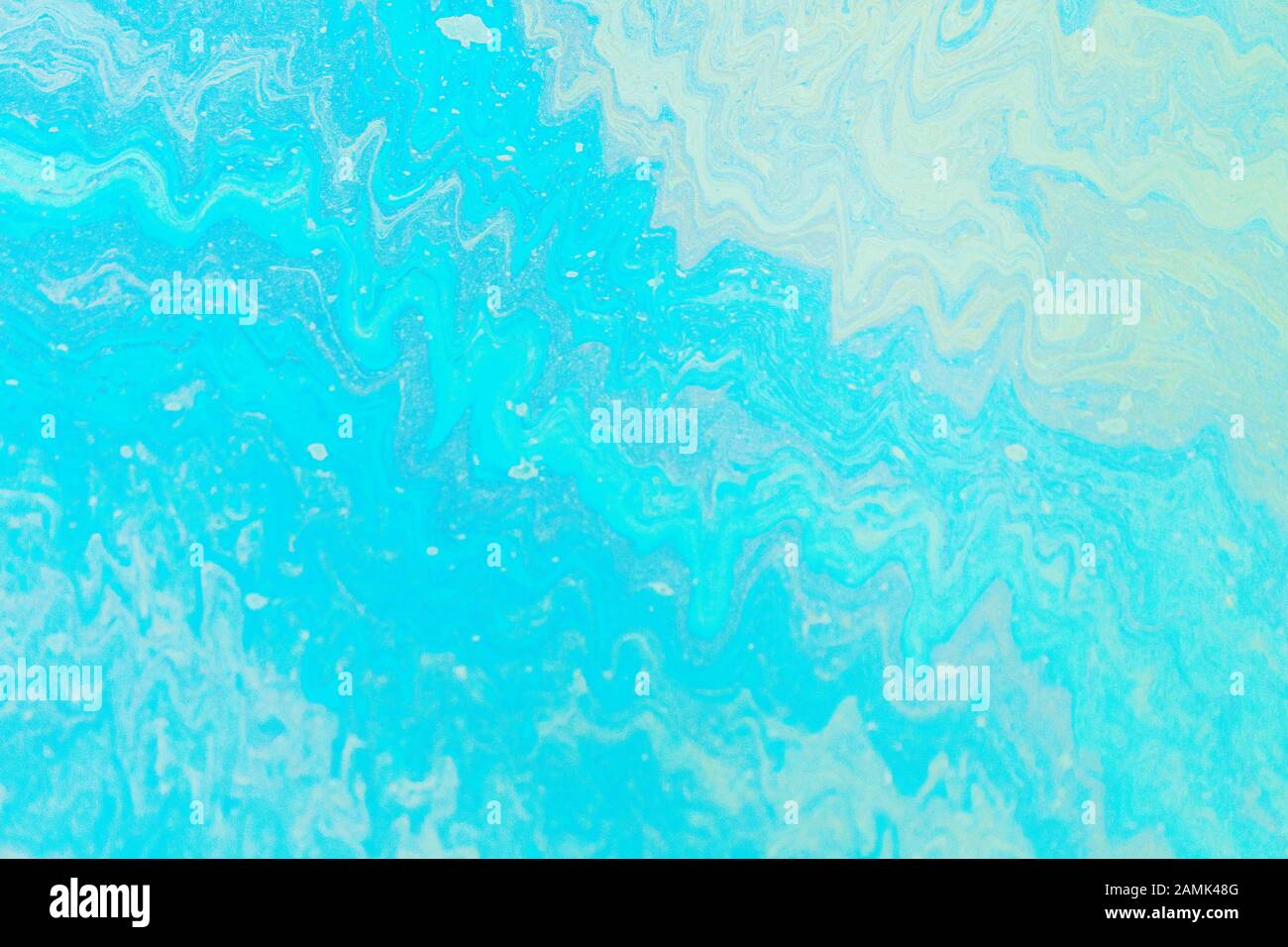 Blue, green, yellow color oil patterns on the surface of the water ...