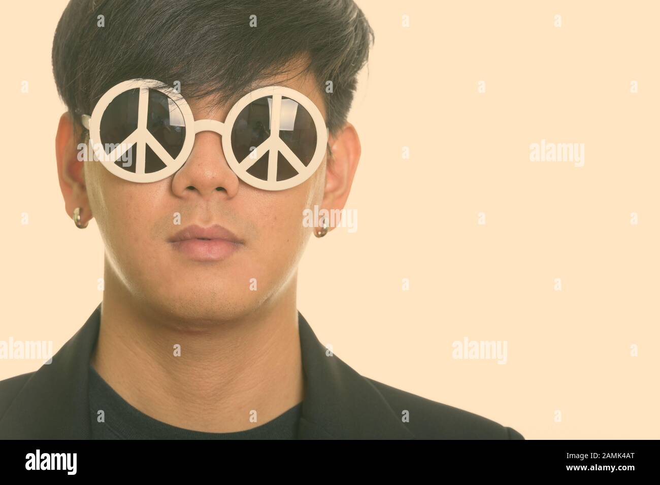Studio shot of young handsome Filipino man isolated against white ...