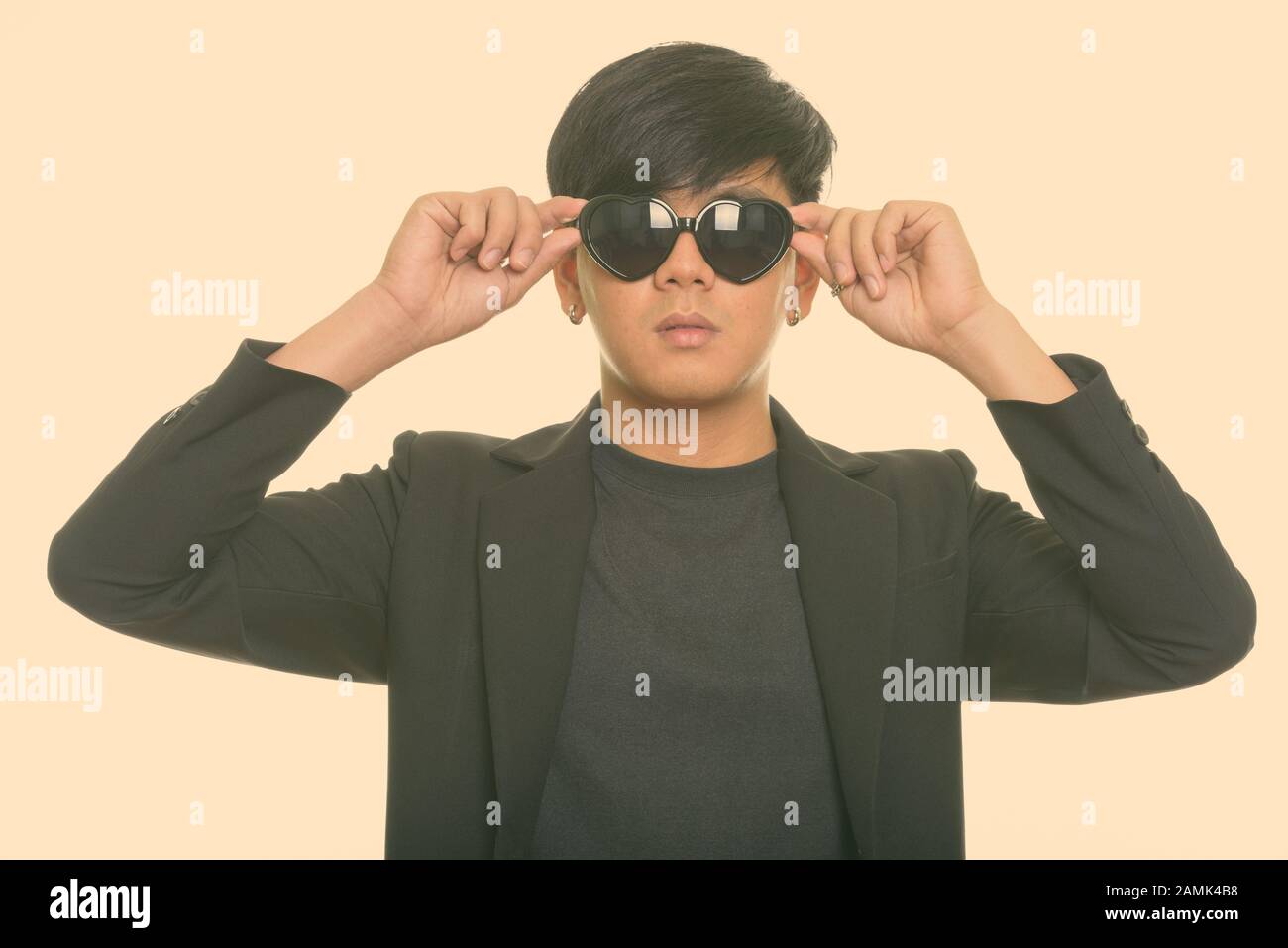 Studio shot of young handsome Filipino man isolated against white ...